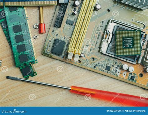 Computer Chip On Electronic Circuit Board Of Pc Motherboard And Screwdriver At Repair Workshop