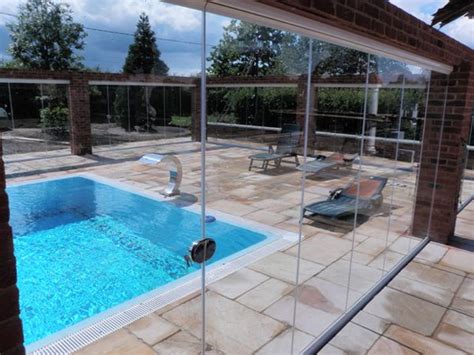 Frameless Glass Doors Installed Around An Outdoor Pool Keeping Off The Chill Winds Frameless