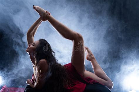 Concept Of Art Creativity And Modern Flexible Sexual Woman On Smoke Background Stock Photo
