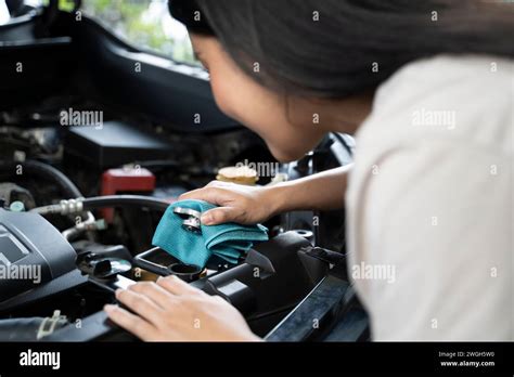 A Woman Is Checking The Engine Coolant Level Stock Photo Alamy
