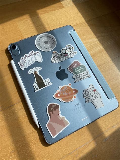 An Ipad With Stickers On It Sitting On A Table