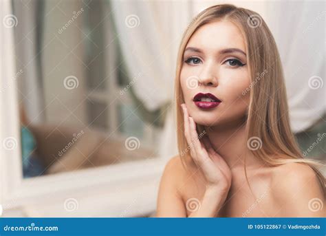 Close Up Photo Of Girl With Makeup She Touches Her Face And Poses For
