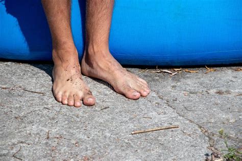 Barefoot Dirty Male Feet On The Hard Surface Of The Ground Stock Image