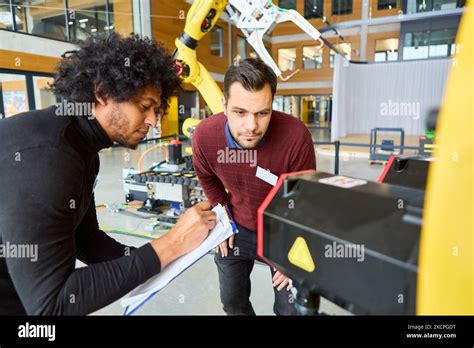 two engineers collaborating on the development and programming of