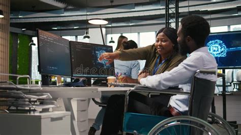 Smiling Startup Engineer And Colleague With Disability Brainstorming