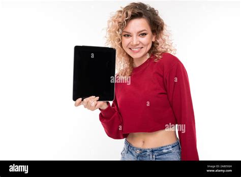 Caucasian Girl With Curly Fair Hair Holds A Tablet And Smiles Portrait