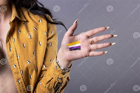 Young Non Binary Woman Showing Non Binary Gender Flag In Hand Close Up