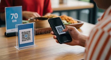 Customer Scanning A Qr Code With Smartphone To Pay For Meal At