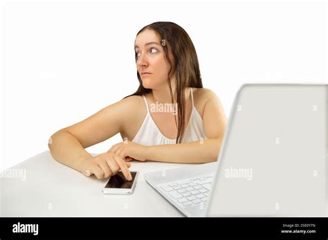 Lazy Female Employee Playing Games With Her Smartphone Sitting In A Desktop Isolated On White