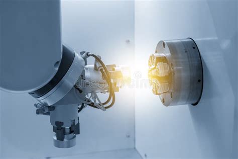 The Automatic Robotic Arm Gripping The Metal Parts From CNC Lathe Machine Stock Photo Image Of