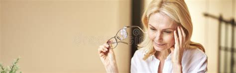 Tired Mature Businesswoman Took Off Her Glasses Feeling Pain