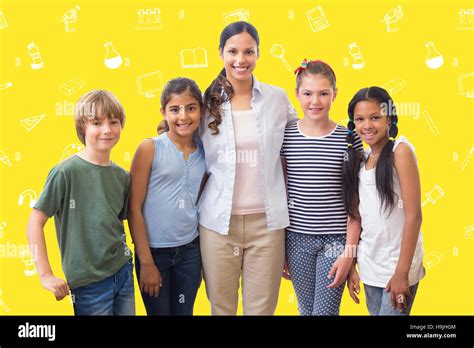 Composite Image Of Cute Pupils And Teacher Smiling At Camera In Computer Class Stock Photo Alamy