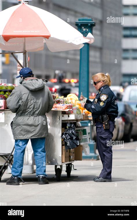 Healthy New York Cop Buying Fruit At A Street Vendor Stall In Lower