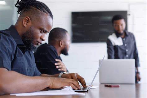 A Group Of People Sitting Around A Computer Photo Web Development