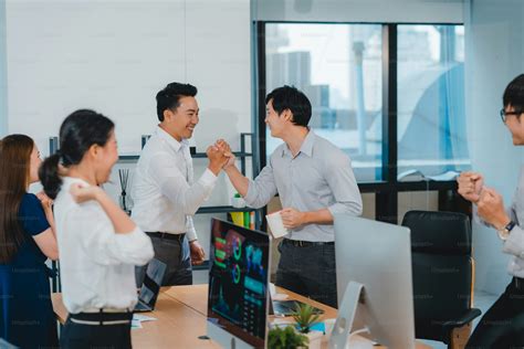 젊은 사업가인 아시아 사업가와 사업가의 밀레니엄 그룹은 작은 현대 사무실의 회의실에서 행복한 느낌을 받고 계약 또는 계약에 서명한 후 5명을 기부하는 것을 축하합니다 사진