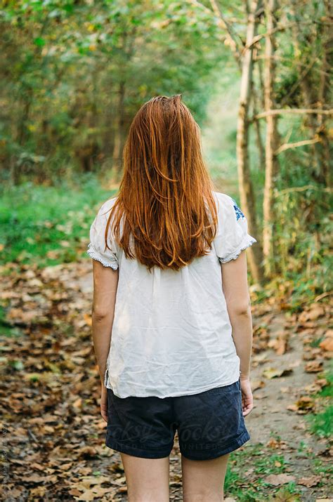 Redheaded Teen Girl From Behind In Autumn Woods By Stocksy