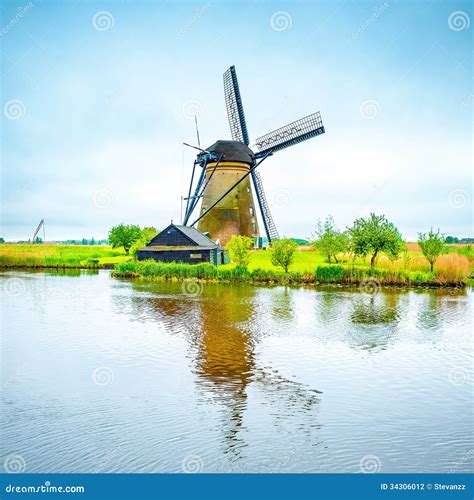 Windmill And Canal In Kinderdijk Holland Or Netherlands Unesco Site