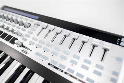 Modern Electronic Keyboard With Control Knobs And Faders For Music Production And Sound Design