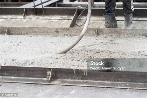 건설 기술자는 콘크리트를 평평하게 하는 동안 콘크리트 진동 발생기를 사용합니다 콘크리트의 최대 강도를 위해 콘크리트 진동기 제거 기포를 사용하는 건설 작업자 강철에 대한