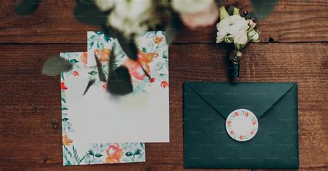 웨딩 부케와 초대장 세련 된 현대 꽃과 꽃 초대 Boutonniere와 나비 넥타이는 나무 배경 평면도에 있습니다 소박한 결혼식 아침의 평평한 누워 텍스트를 위한 공간