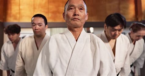 Black Belt Students Bow Or Sensei In Class For Aikido Practice