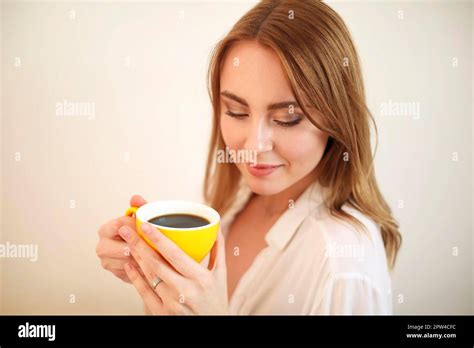 Adult Female In Robe Closing Eyes While Having Cup Of Aromatic Freshly