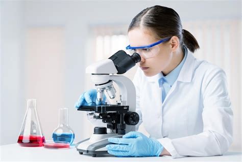 Premium Photo Young Female Scientist Uses A Microscope In The Laboratory