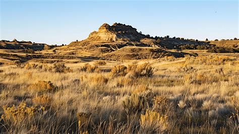 Rural Buttes And Scrub In The Landscape Of North Dakota Background