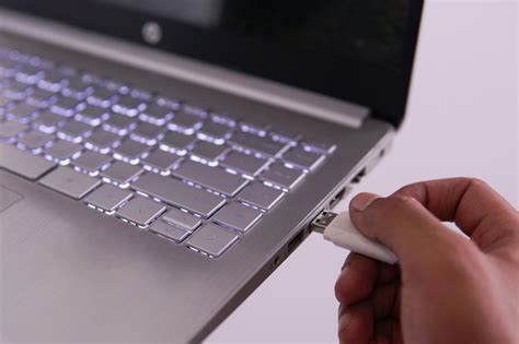 Premium Photo Usb Plugged Into The Laptop For Data Transfer With Hand