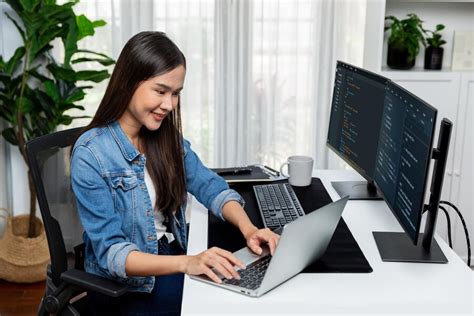 Premium Photo Smiling Asian It Typing Online Software Development On Laptop Stratagem