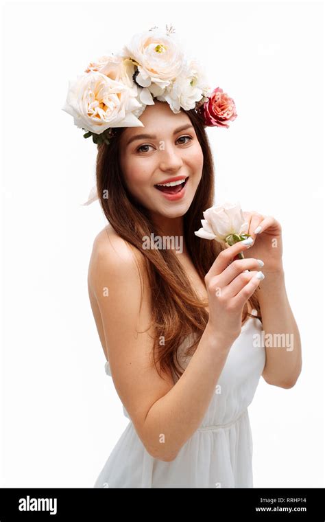 Beautiful Young Girl Smiling And Posing With Flowers On White