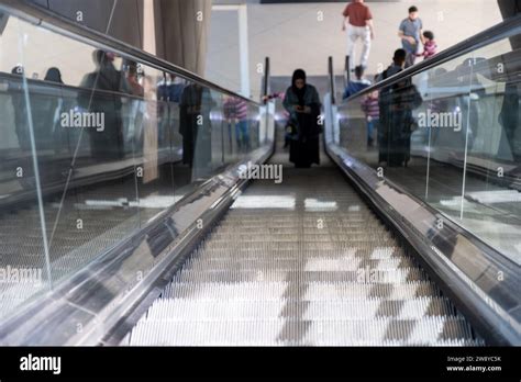 Female Using Escalator To Go Up To Next Floor Stock Photo Alamy