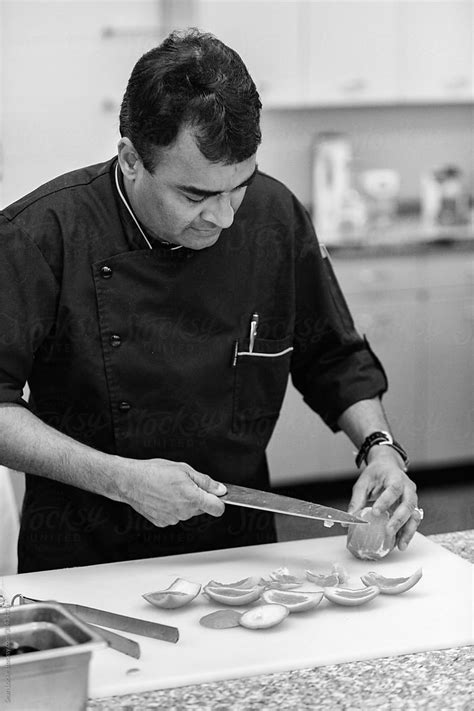 Class Chef Slices Peel From Orange By Stocksy Contributor Sean Locke Stocksy