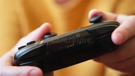 woman hands holding black joystick gamepad playing game console