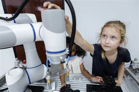 Girl Caucasoid Education Electronic Robotic Arm On Table At Class Room Learning Innovation