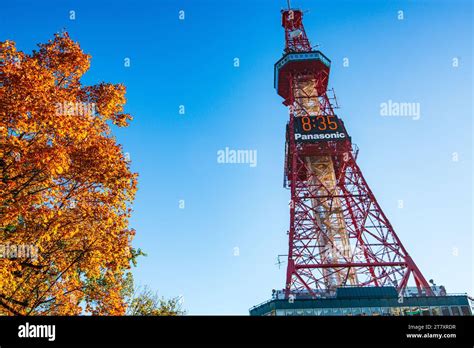 Close Up Of Sapporo Tower With Red Maple Autumn Leaves Against Blue Sky Sapporo Hokkaido