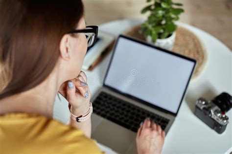 Mockup White Screen Laptop Woman Using Computer While Sitting At Table At Home Back View Stock