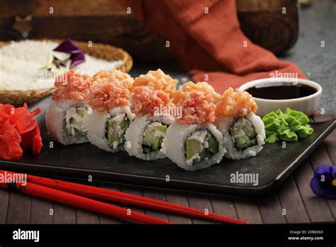 A Shot Of Vegetable Sushi Roll With Assorted Veggies And A Side Of