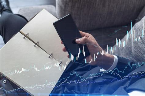 Premium Photo Trader Holding In The Hands A Smart Phone And Researching Stock Market To