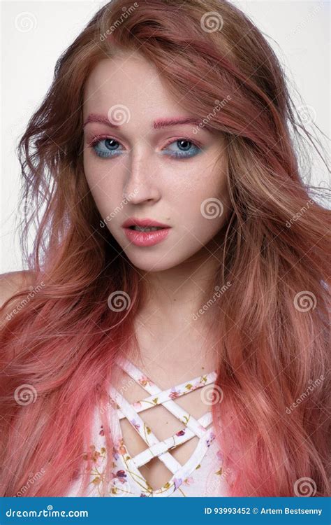 Close Up Portrait Of Beautiful Girl With Pink Hair And Pink And Blue Make Up On Light Background