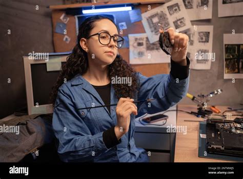 Female Repairman Fixing Broken Laptop In Retro Repair Shop Or Garage Fixing Laptop