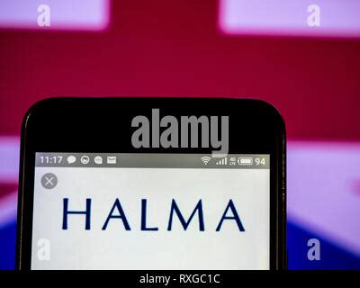 The Halma Plc Logo Is Seen On An Led Screen In The Background While A