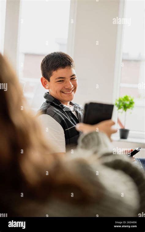 Girl Showing Brother Smart Phone Stock Photo Alamy