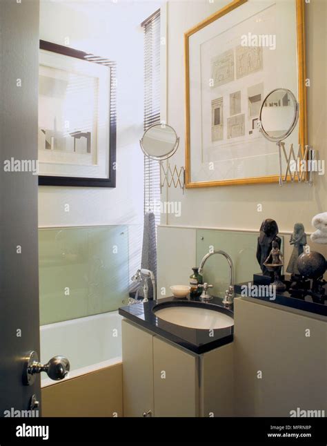 A Detail Of A Modern Bathroom Wash Basin Set In Cupboard Unit Perspex Splashback Extending