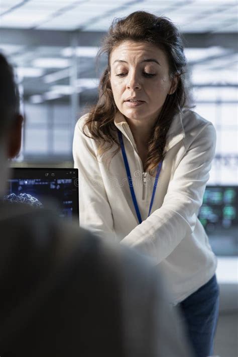 Supervisor Overseeing Employees In Server Farm Testing Equipment Stock