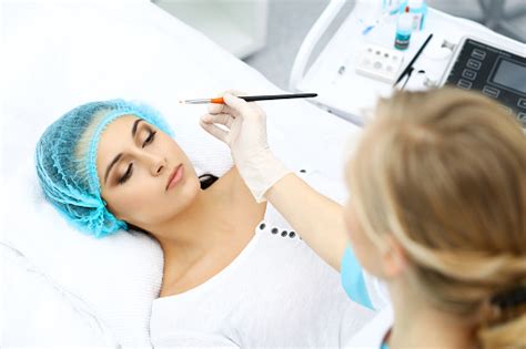 전문 미용사 여자 얼굴에서 눈 썹 문신을 하 고입니다 뷰티 살롱 근접 촬영에서에서 영구이 마 메이크업입니다 미용 치료입니다 건강관리와 의술에 대한 스톡 사진 및 기타 이미지