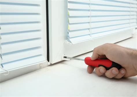 Premium Photo Man Installing Window Blinds At Home Close Up