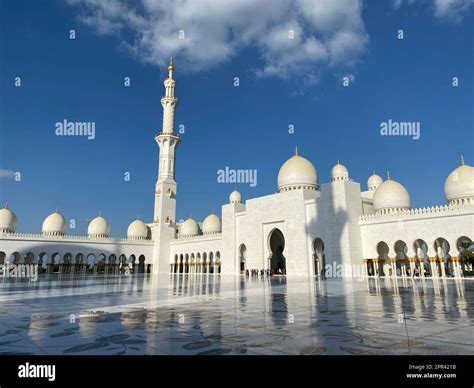 The Majestic Sheikh Zayed Grand Mosque In All Its Glory Against A Bright Azure Sky Creating A