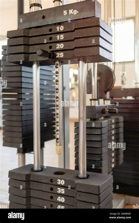 From Below Of Weight Lifting Stack Machine With Set Of Rectangular Plates Pierced With Bars And