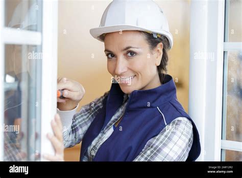 A Female Builder Fixing The Window Stock Photo Alamy